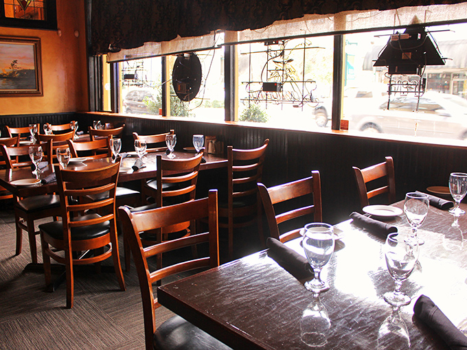 Sunlight streams through windows onto wooden tables set for the evening's symphony of steak and conversation.