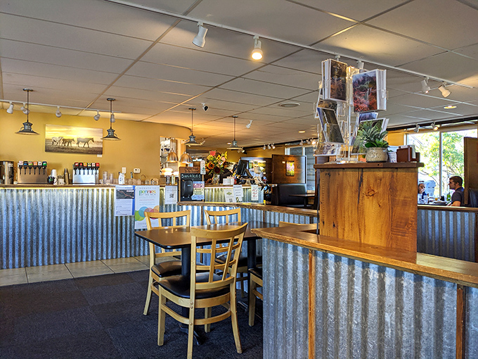 Corrugated metal meets warm wood in a dining space where mountain photos remind you of the adventures waiting after your meal.