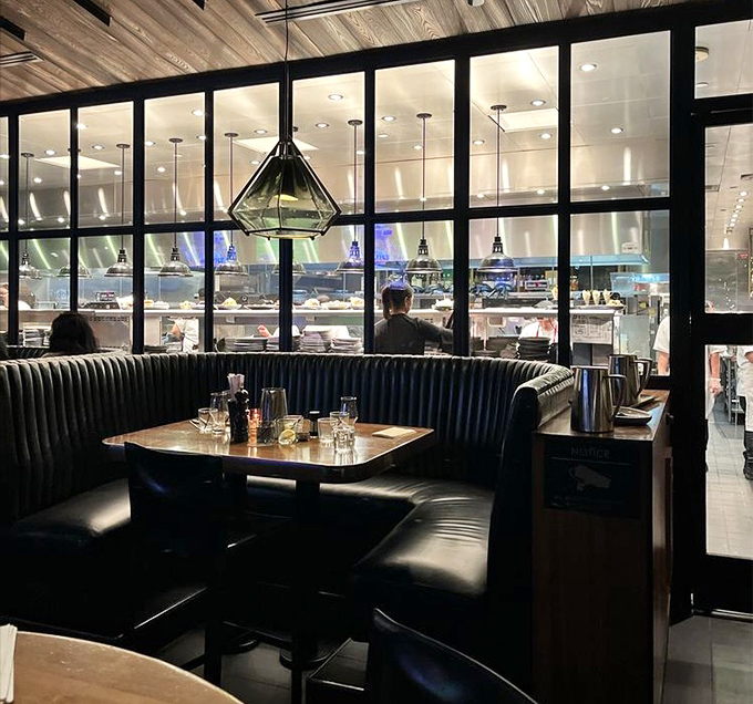 The open kitchen design isn't just trendy&mdash;it's dinner and a show, with the glass partition offering a glimpse into the culinary choreography.