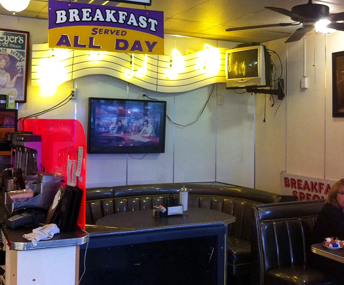 The "Breakfast Served All Day" sign glows like a beacon of hope for those of us who believe pancakes know no time constraints.