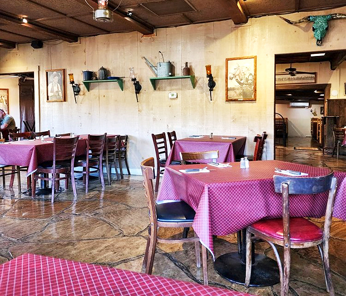 Red checkered tablecloths and rustic walls create the kind of authentic Western atmosphere that chain restaurants spend millions trying (and failing) to replicate.