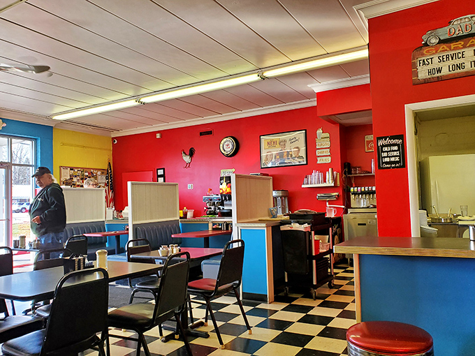 Vibrant red walls and retro blue booths create the perfect backdrop for conversations that flow as freely as the coffee.
