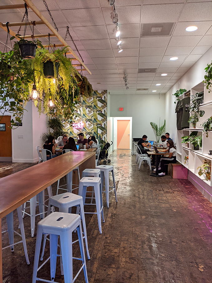 A long wooden bar with hanging plants creates the perfect perch for people-watching or laptop warriors seeking caffeinated inspiration.