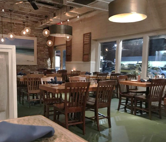 Warm wood tones and thoughtful lighting create the perfect backdrop for seafood stories. Nautical without going overboard on the theme.