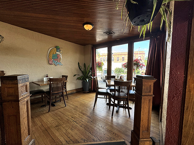 Wooden floors, warm tones, and hanging plants create a dining space that feels like the living room of your coolest friend who happens to cook brilliantly.