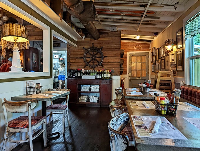 Nautical nostalgia meets dining comfort. That ship's wheel on the wall has probably seen fewer journeys than their seafood.