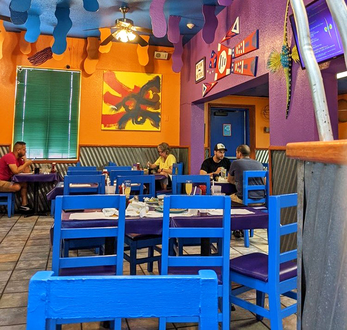 The dining area's bold colors and playful ceiling decorations create an atmosphere that's equal parts art gallery and comfort zone.