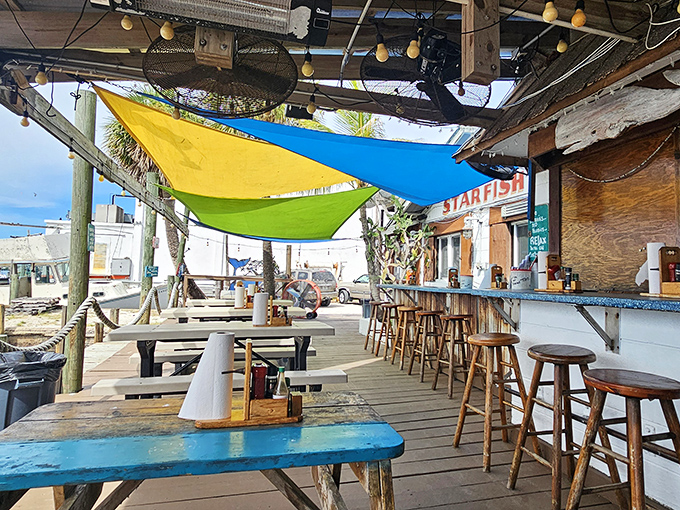 Million-dollar views without the price tag. Colorful sunshades and weathered wood create the perfect setting for seafood feasting with water views.