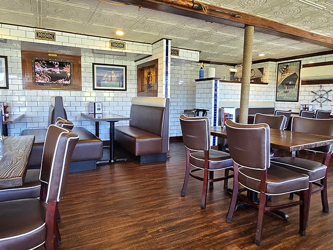 Nautical-meets-comfortable in the dining room, where white subway tiles and maritime photos remind you that your dinner was recently swimming.