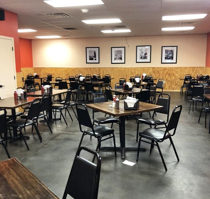 The dining room says "focus on the food." Those framed photos on the wall have seen generations of sauce-stained smiles.