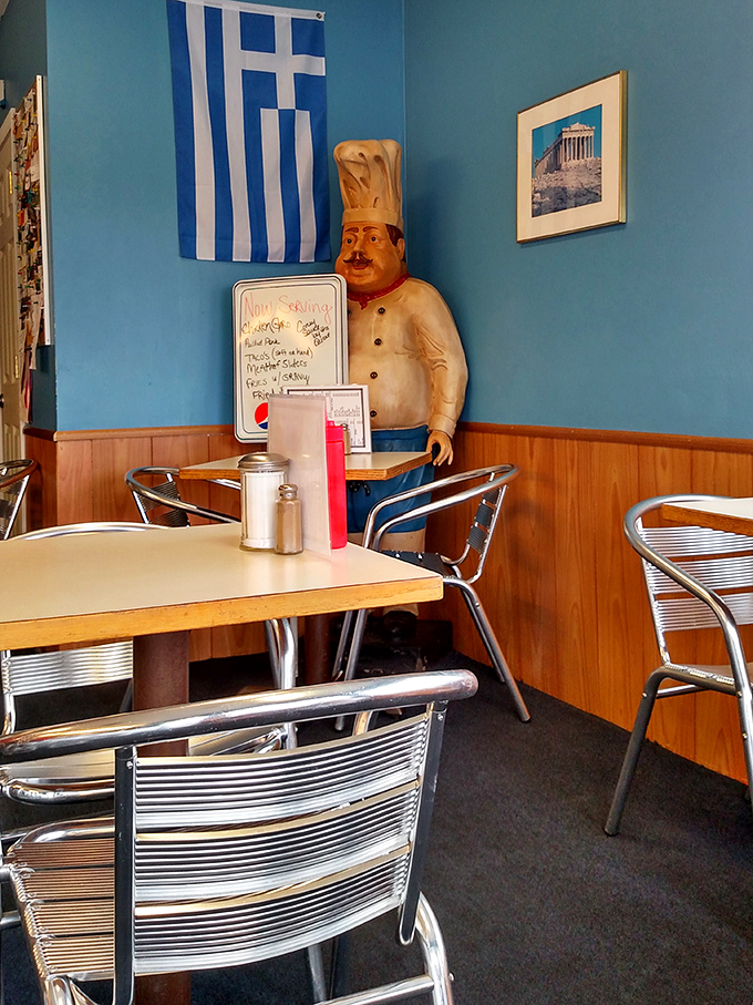 Blue walls, Greek flag, and a chef statue standing guard&mdash;this dining area feels like your favorite uncle's kitchen, if he happened to be Greek.