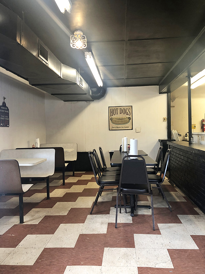 No-frills dining at its finest&mdash;just clean tables, sturdy chairs, and a hot dog sign that promises simple pleasures done right.