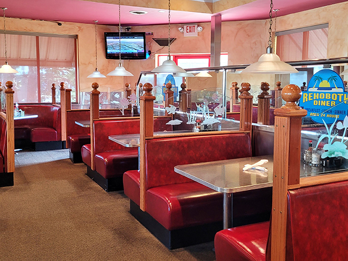 Classic diner geometry: red booths, wooden dividers, and pendant lights creating the perfect equation for comfort. Math you can actually use.