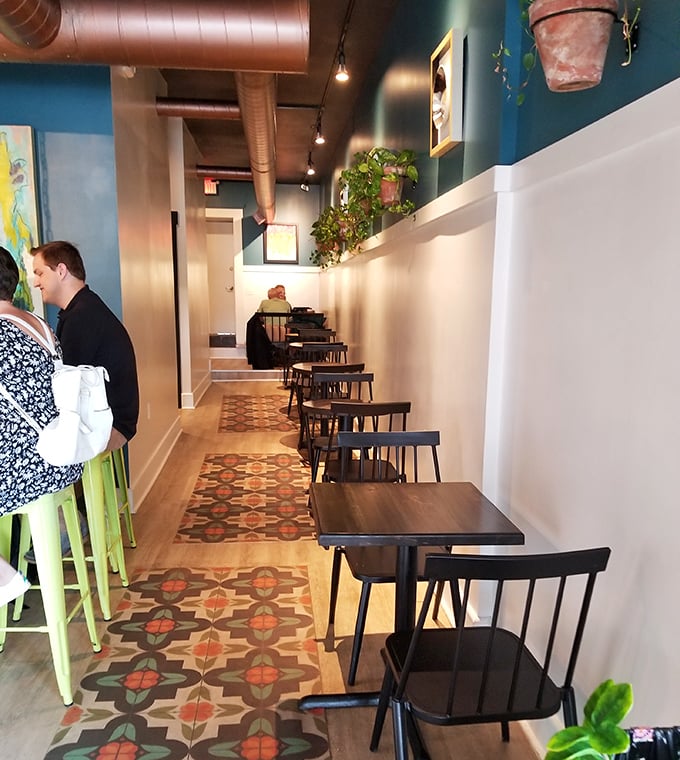 The dining area whispers "stay awhile" with its pattern-tiled floor and minimalist charm. A place where conversations flow as smoothly as the coffee.