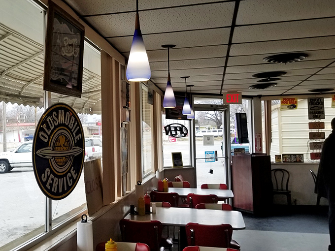 Classic diner aesthetics with pendant lighting and "Oldsmobile Service" nostalgia. The perfect backdrop for serious barbecue contemplation.