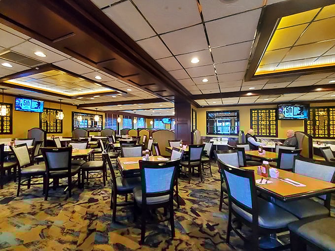 The dining room &ndash; where strangers become neighbors over plates of pancakes. Modern lighting casts a warm glow over conversations and comfort food.