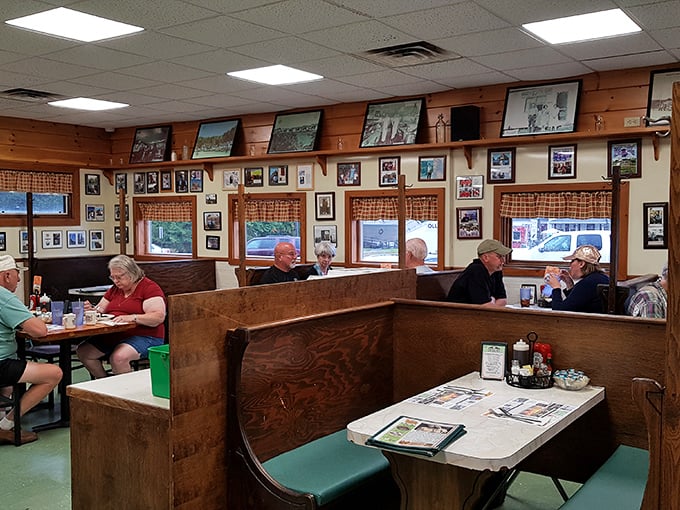 High-backed wooden booths create cozy dining spaces where families, friends, and solo travelers share the universal language of good food.