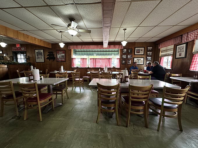 Red checkered curtains and wood-paneled walls create the perfect backdrop for barbecue memories. No designer needed&mdash;just decades of satisfied customers.