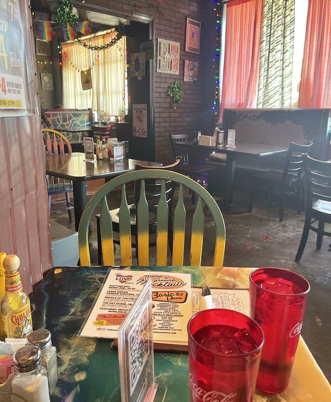 Mismatched chairs, string lights, and Coca-Cola glasses create that rare atmosphere where strangers become friends over shared tables and breakfast stories.