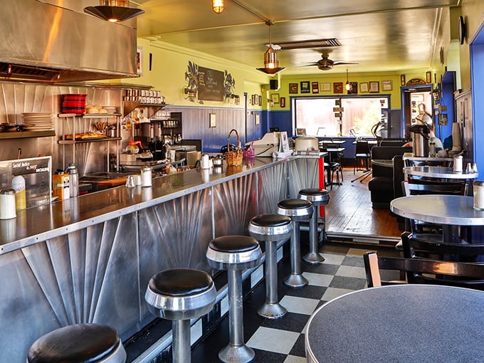 Classic diner counter seating where dreams and maple syrup flow freely&mdash;the stainless steel backdrop is practically a breakfast theater stage.