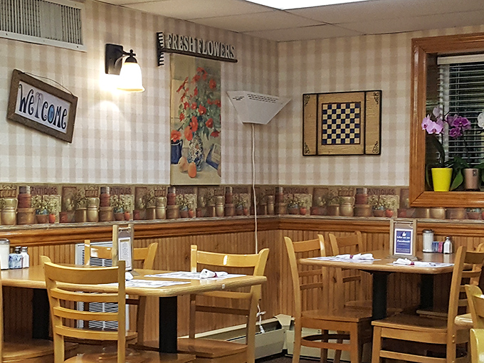 The dining area whispers "welcome home" with its checkered wall border and wooden wainscoting. Even the chairs look like they want to hear about your day.
