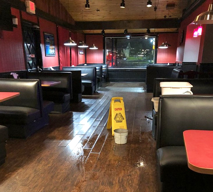 Red walls and dark wood create the perfect backdrop for seafood feasting—like dining in the cozy cabin of a particularly delicious ship.