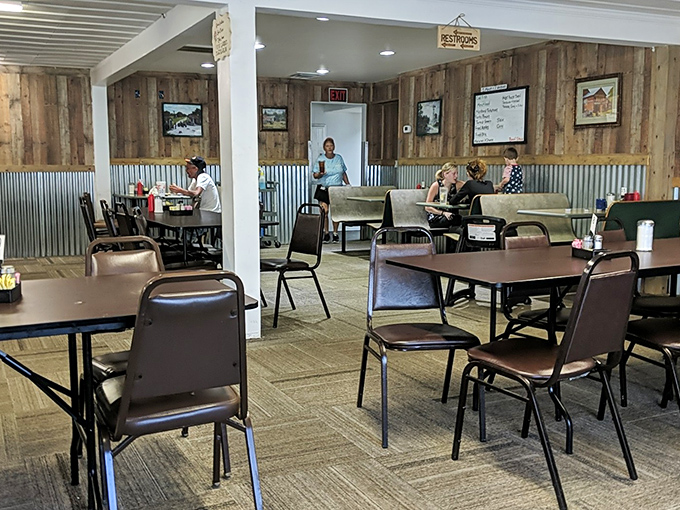 The dining room's rustic charm comes from wood paneling and corrugated metal accents &ndash; Tennessee's version of farmhouse chic before it was trendy.