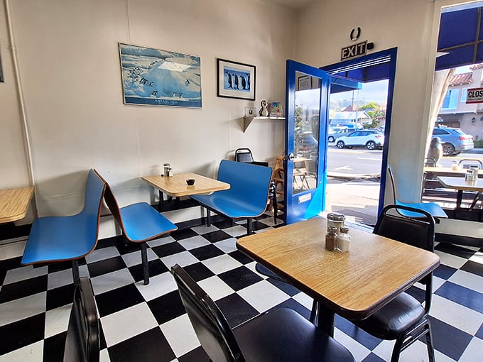 Classic black and white checkered floors, blue booths, and penguin art create the diner atmosphere that fancy brunch spots try (and fail) to replicate.