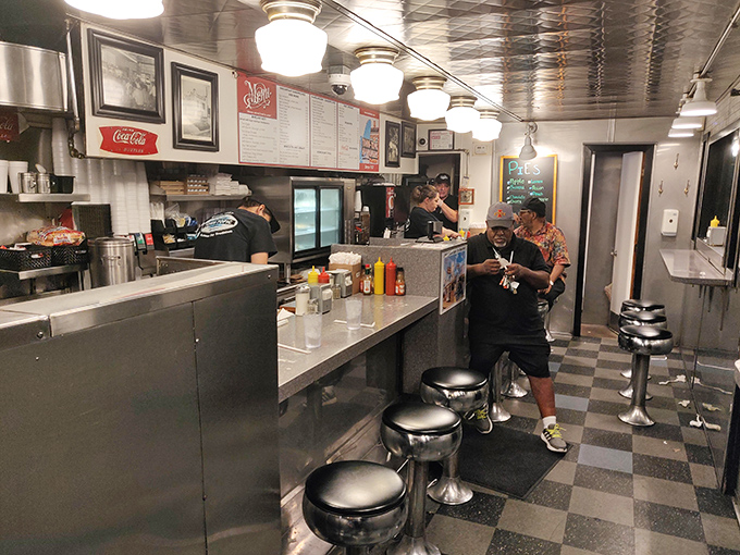 Classic diner geometry: chrome stools, checkered floors, and countertops that have hosted countless elbows and life stories since opening day.