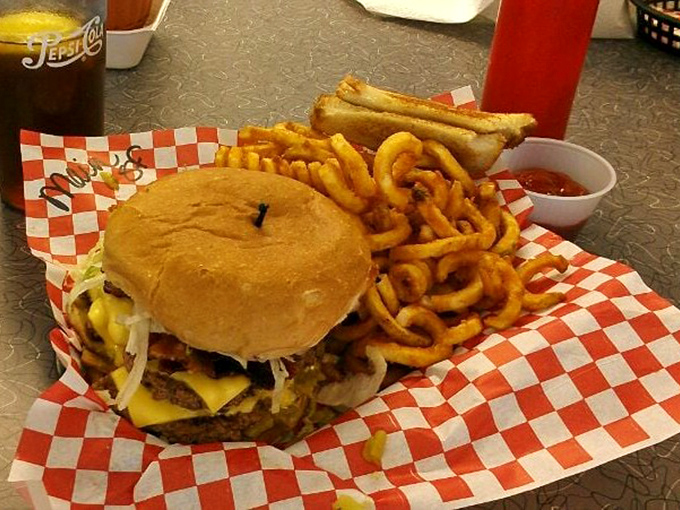A burger so impressive it deserves its own ZIP code, served with curly fries that dance around your plate.