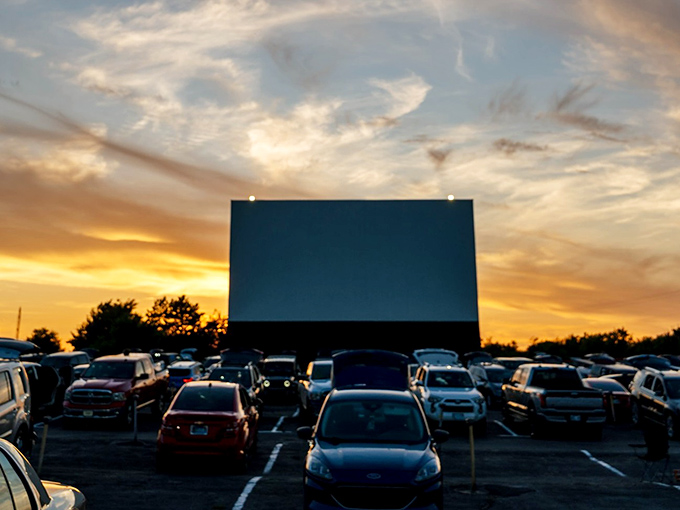 As daylight fades, a sea of vehicles settles in, each a private theater box under the vast Oklahoma sky—Netflix could never.