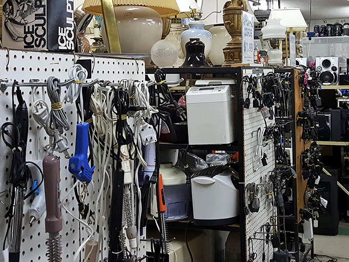 The electronics graveyard: where power cords tangle like technological spaghetti and yesterday's must-have gadgets await their second chance at usefulness.