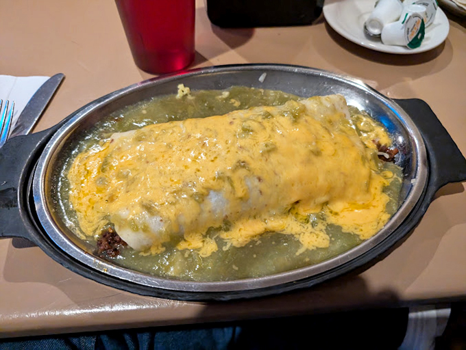 A burrito swimming in green chile sauce that's practically doing the backstroke. This isn't food; it's an edible warm hug.