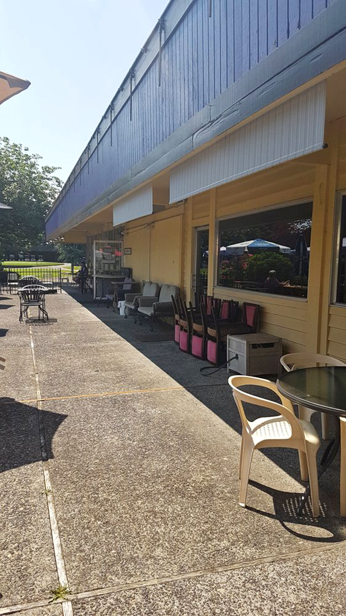 Yellow siding and outdoor seating that whispers "stay awhile" on sunny Pacific Northwest days. A patio that invites lingering conversations.
