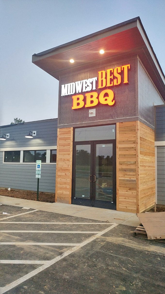 As dusk falls, the illuminated sign glows like a barbecue bat signal, calling hungry souls to gather for a proper Midwest meat feast.