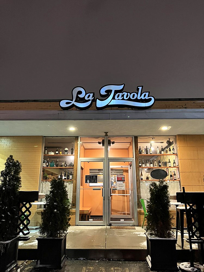 The illuminated sign at dusk makes this place glow like a beacon for anyone craving authentic Italian comfort food.