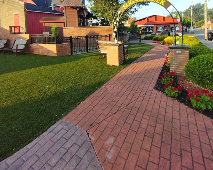 The brick pathway invites visitors to stroll through Sugarcreek's charming downtown, where every bench promises a front-row seat to small-town life.