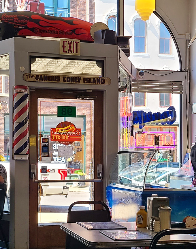 The exit sign might say "way out," but the barber pole and vintage decor say you're already exactly where you need to be.