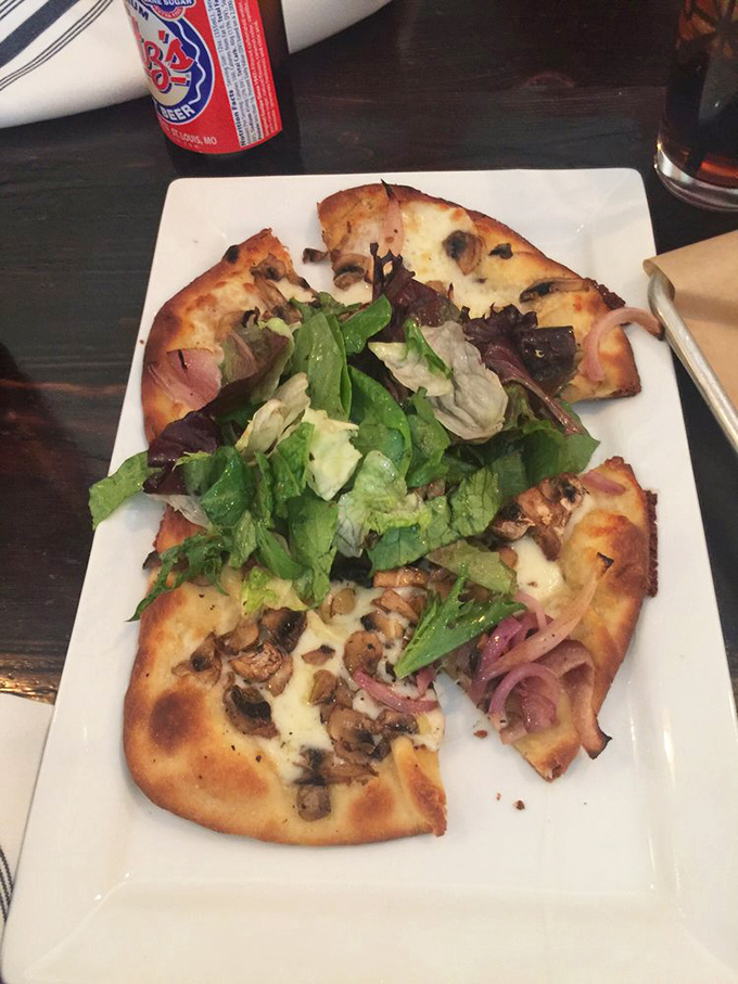 Flatbread that's achieved the perfect balance of crispy and chewy, topped with mushrooms and greens. Pizza's sophisticated cousin has arrived at the party.