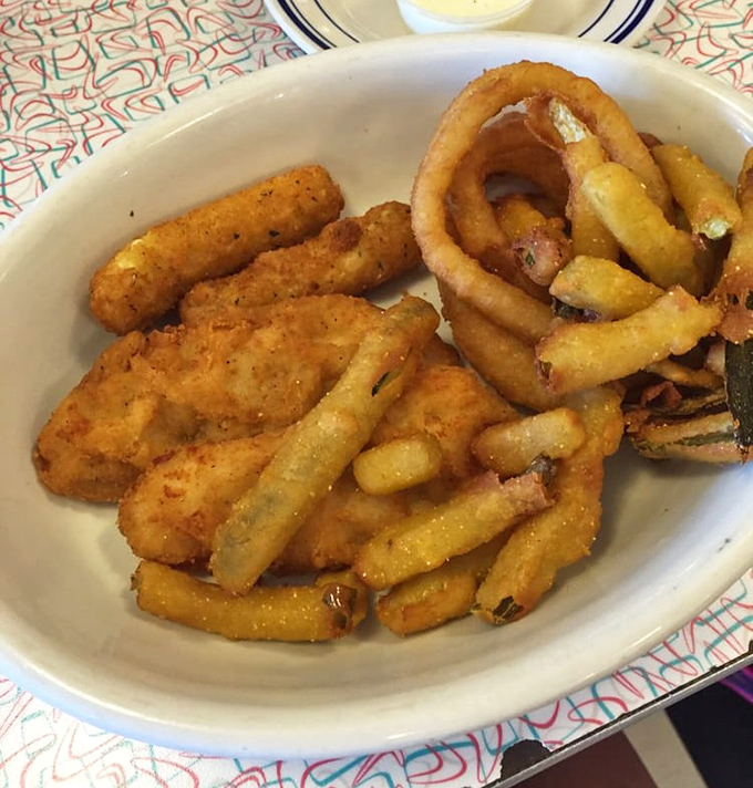 Golden-fried perfection on a plate &ndash; where onion rings, chicken tenders, and mozzarella sticks form a triumvirate of crispy indulgence.