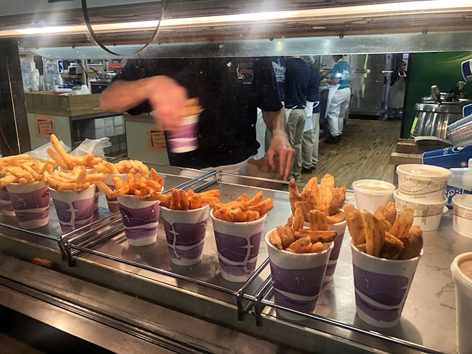 French fries standing at attention in their purple cups, ready to accompany the main event or steal the spotlight all on their own.