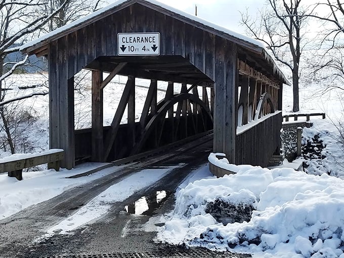 Winter transforms the bridge into a snow-dusted passage that would make Norman Rockwell reach for his paintbrush.