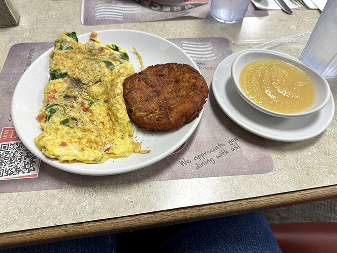 A garden omelet that actually delivers on the "garden" promise—vibrant vegetables folded into perfectly cooked eggs. That biscuit looks like it could solve all of life's problems.