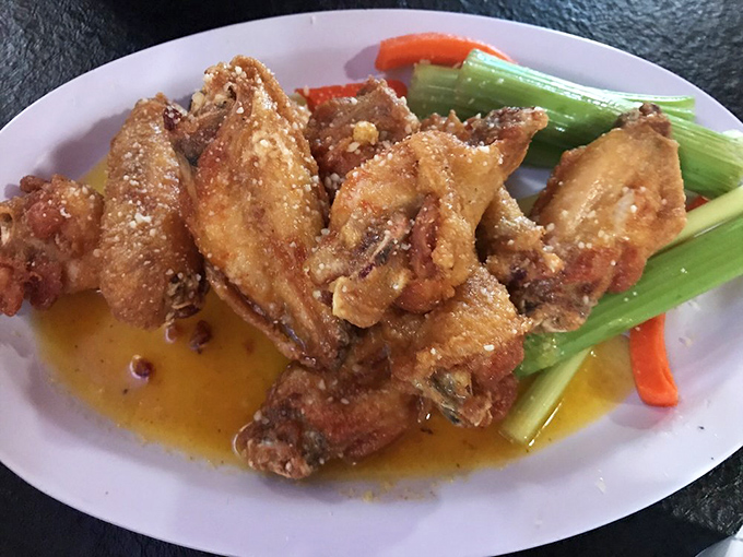 These wings aren't just fried, they're transformed &ndash; glistening with sauce and surrounded by cooling celery like tasty little life rafts.