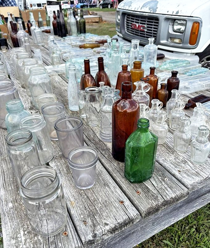 Vintage bottles catch the light like liquid jewels. Each glass vessel whispers tales of old pharmacies, soda fountains, and prohibition-era speakeasies.