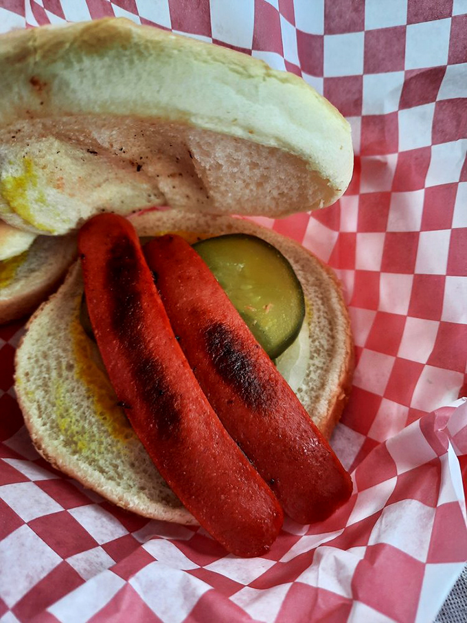 This hot dog, grilled to snappy perfection and nestled in a soft bun with pickle and mustard, is childhood nostalgia served with a side of grown-up satisfaction.