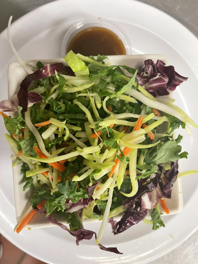 A fresh garden salad that offers a crisp, verdant respite between bouts of seafood indulgence&mdash;balance in all things, even feasting.