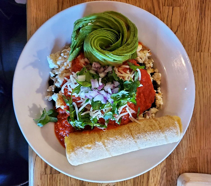 A beautiful rose of avocado crowns this Mexican-inspired masterpiece. It's not just breakfast &ndash; it's edible art with a kick.