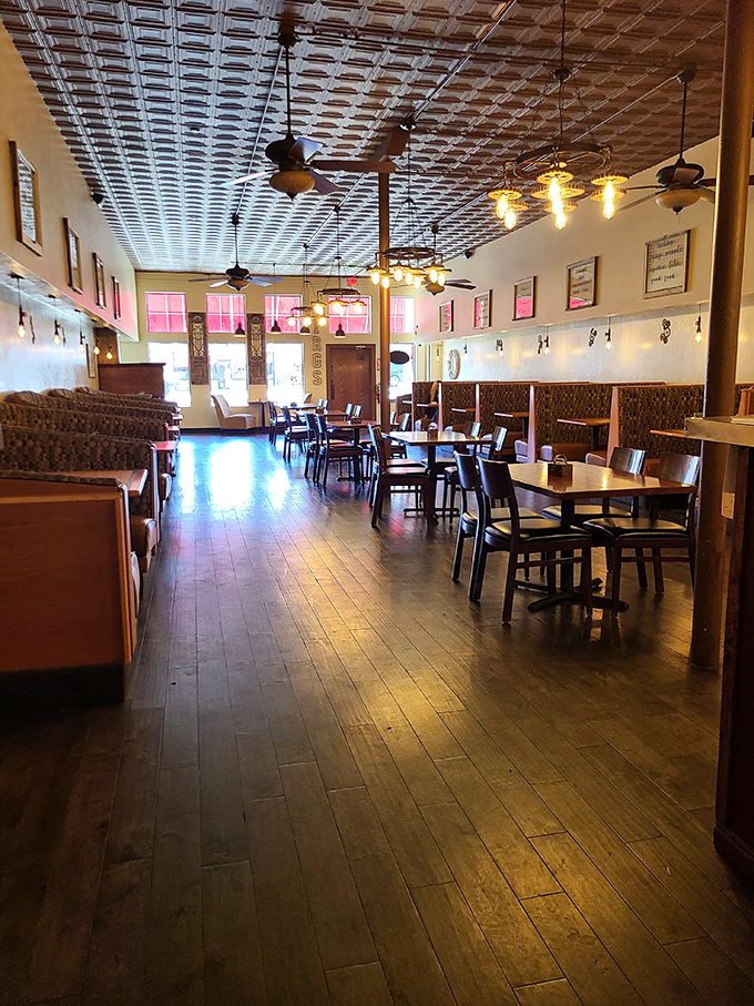 The warm wooden floors and tin ceiling create the kind of atmosphere where strangers become regulars and regulars become family. No designer needed, just decades of good vibes.