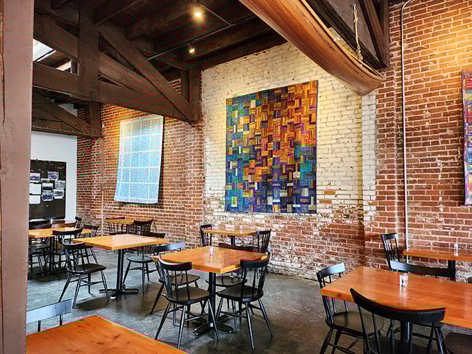 Exposed brick, colorful artwork, and wooden beams create an atmosphere that makes lingering over breakfast feel absolutely mandatory.